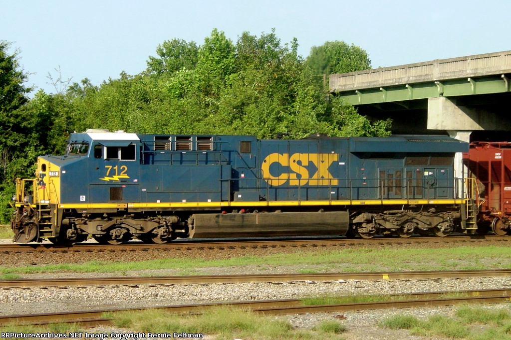 CSX ES44AC #712 easing away from the Manchester yard office towards the absolute signal at the ...